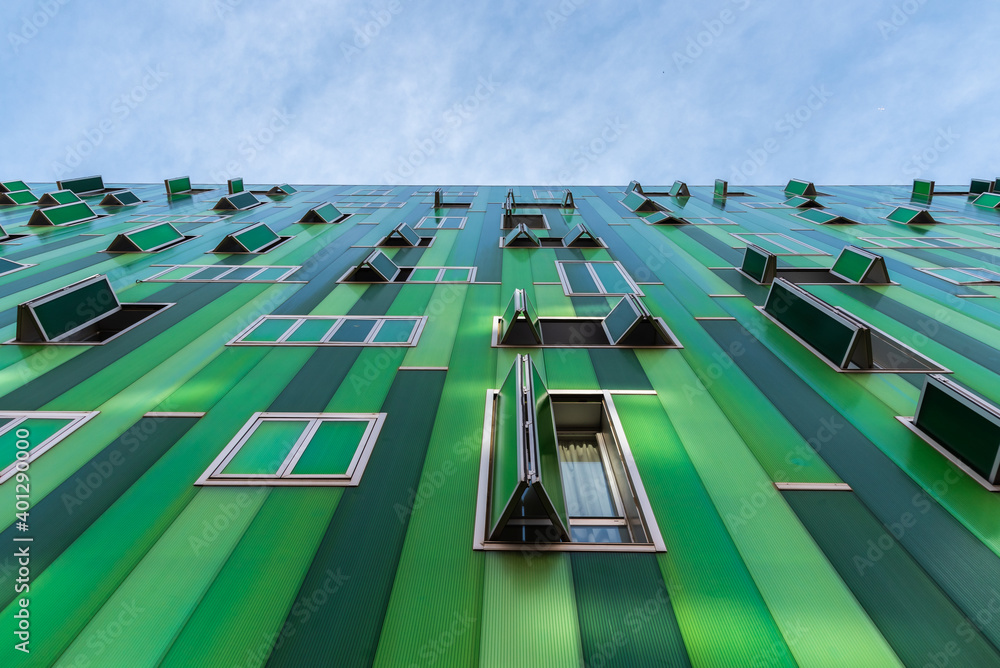 From below contemporary building with vivid green facade and opened ...