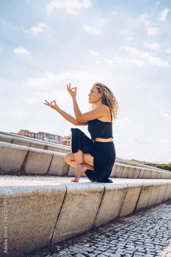 Full body side view of concentrated female in black sportswear doing ...