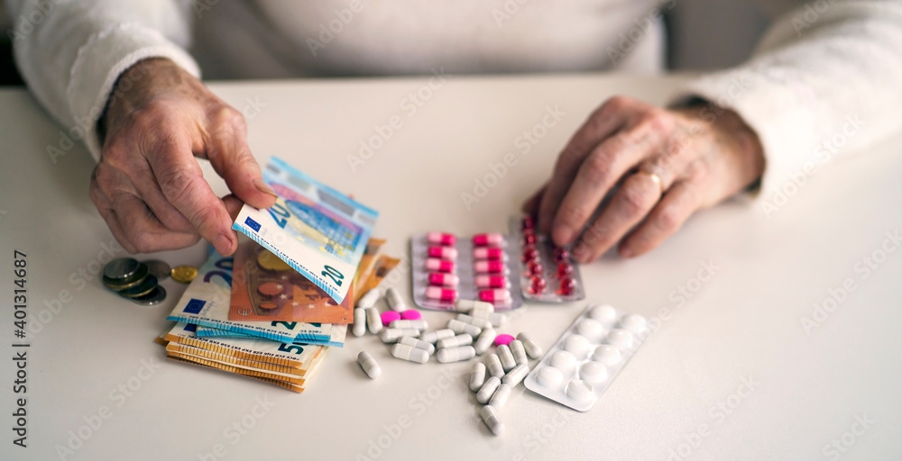An older retired woman is counting money and saving it for medicines ...