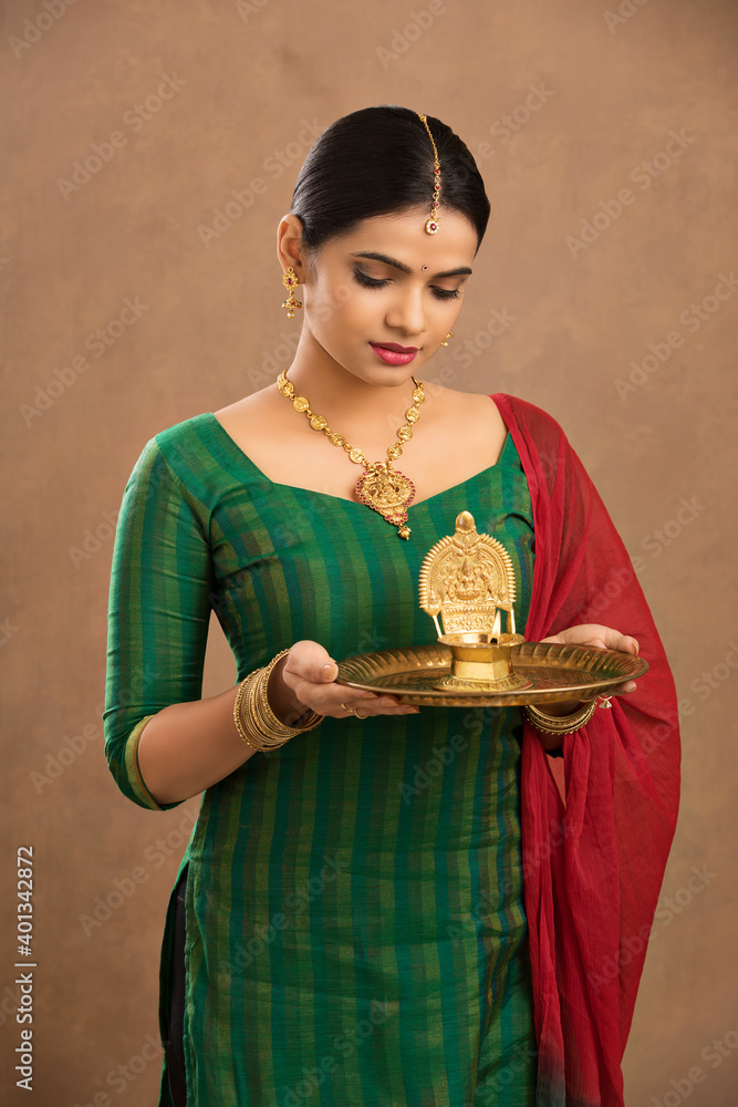 Hindu Indian young women holding Deepam in hands studio shot ...