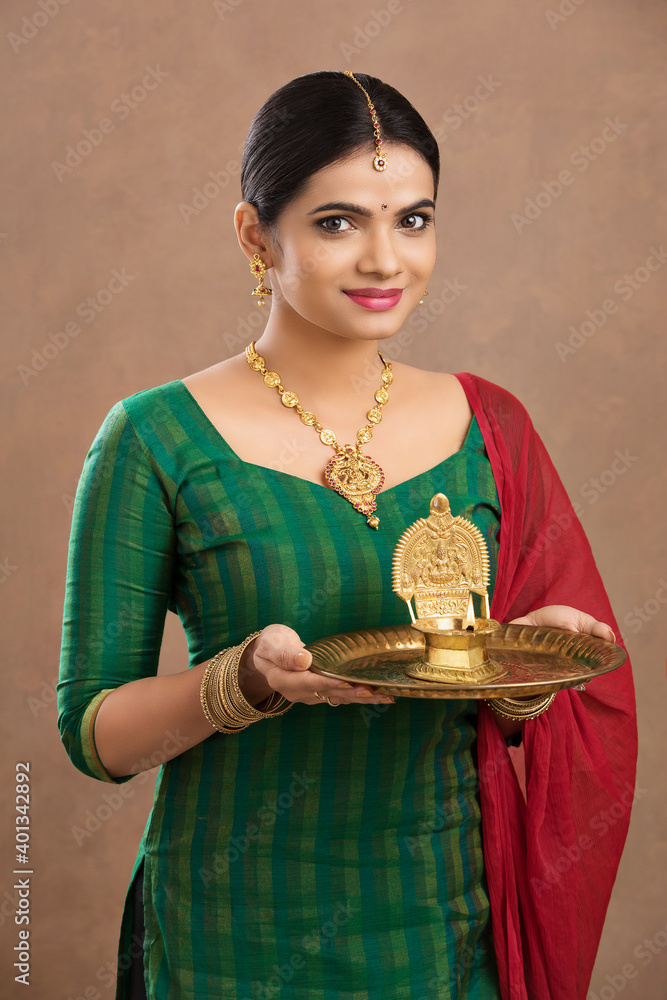 Hindu Indian young women holding Deepam in hands studio shot ...