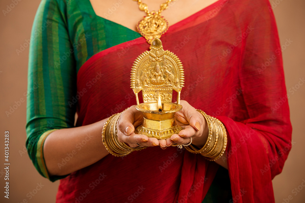 Hindu Indian young women holding Deepam in hands studio shot ...