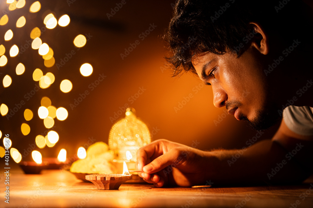 Indian young man lightening deepa for celebrating Diwali Stock Photo ...