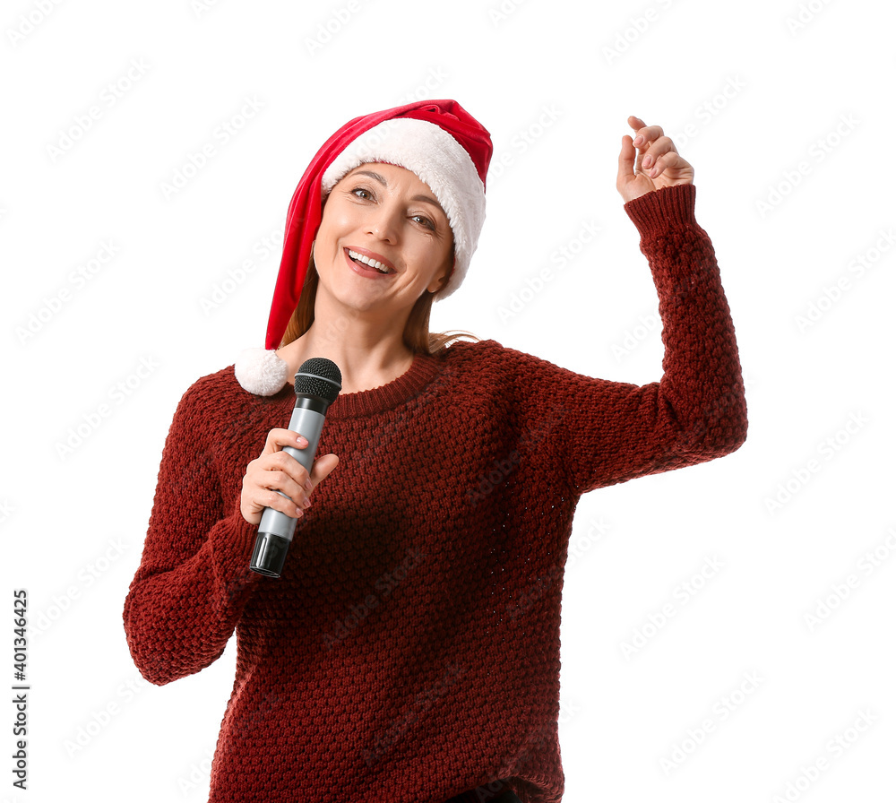Mature woman with microphone singing Christmas song on white background ...