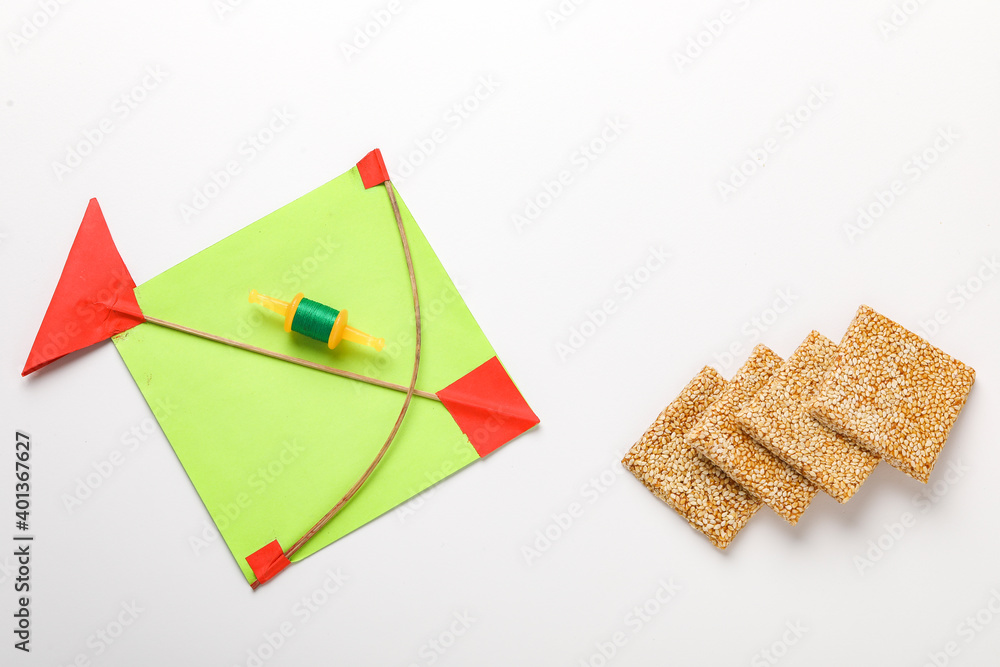 indian sweet chikki made from sesame seed with colorful paper kite for ...