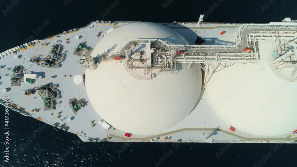 Aerial top down epic huge tanker ship gas carrier, floats across sea ...
