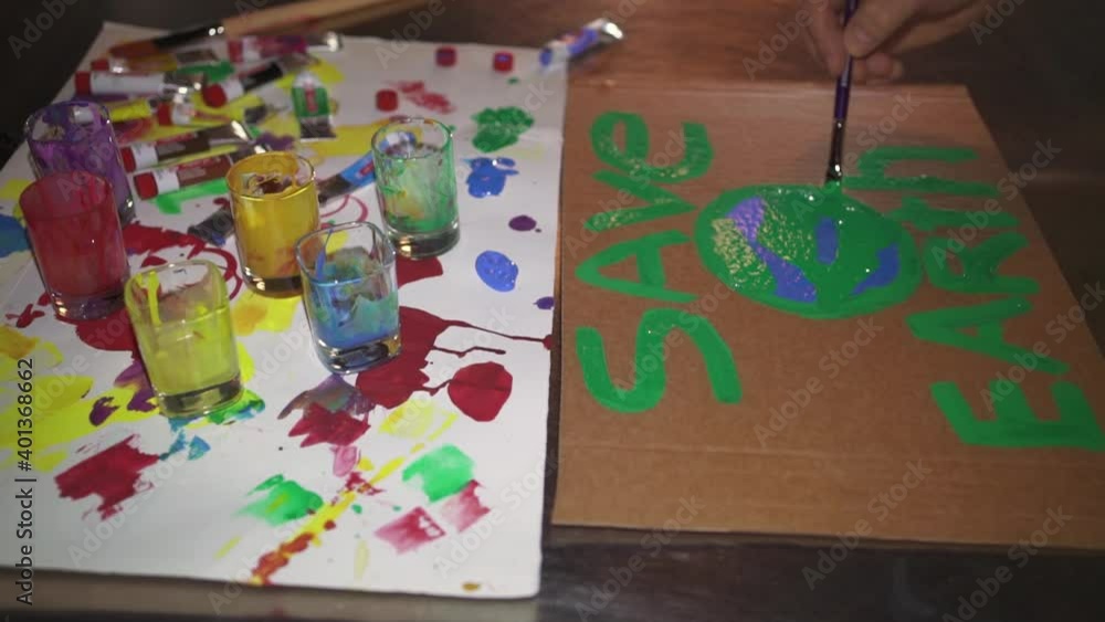 Human hands paint our earth green and blue with a request to keep the ...