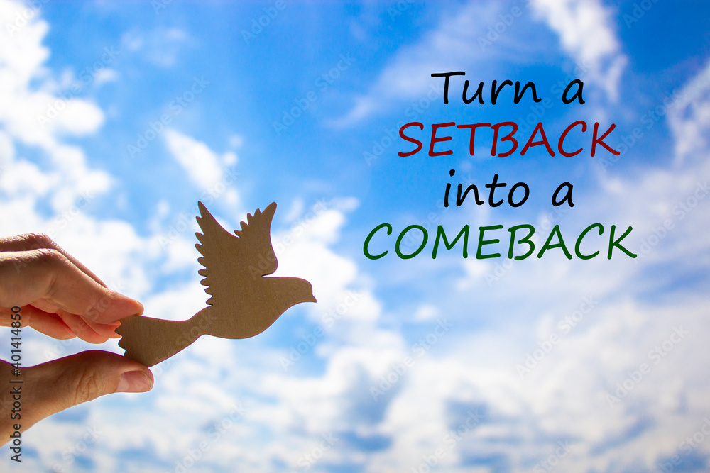 Setback or comeback symbol. Man hand holding wooden bird on cloud sky ...