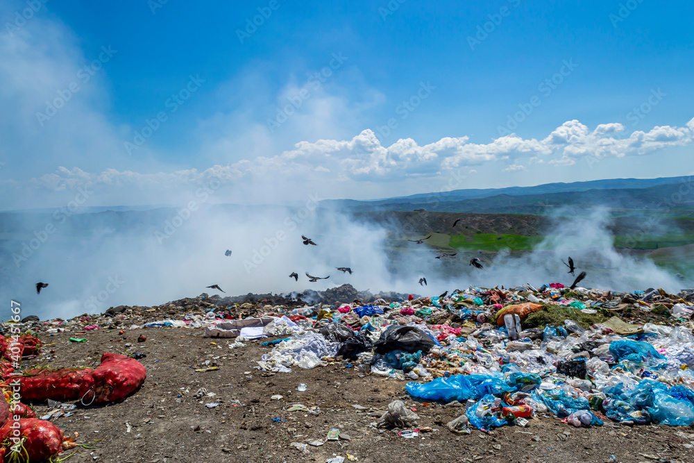 View of garbage field in trash dump or open landfill, food and plastic ...
