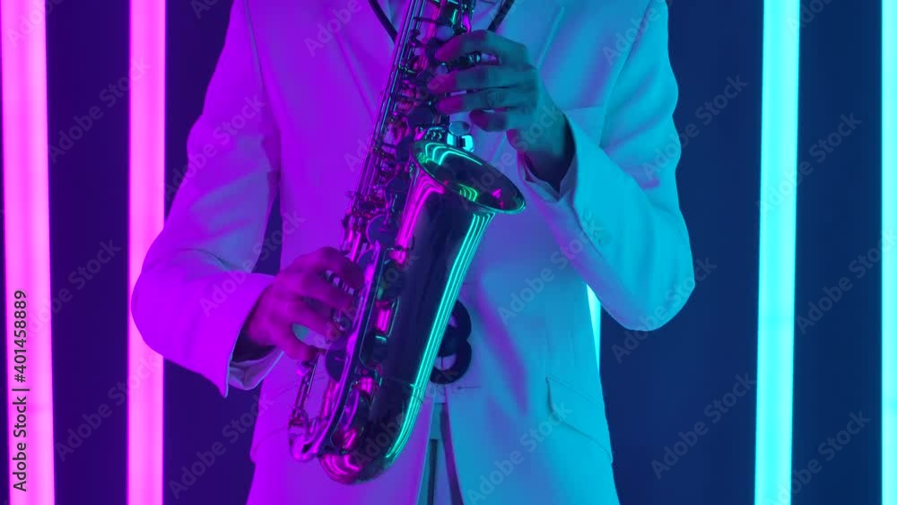 Golden shiny saxophone close up. Detailed footage of male hands ...