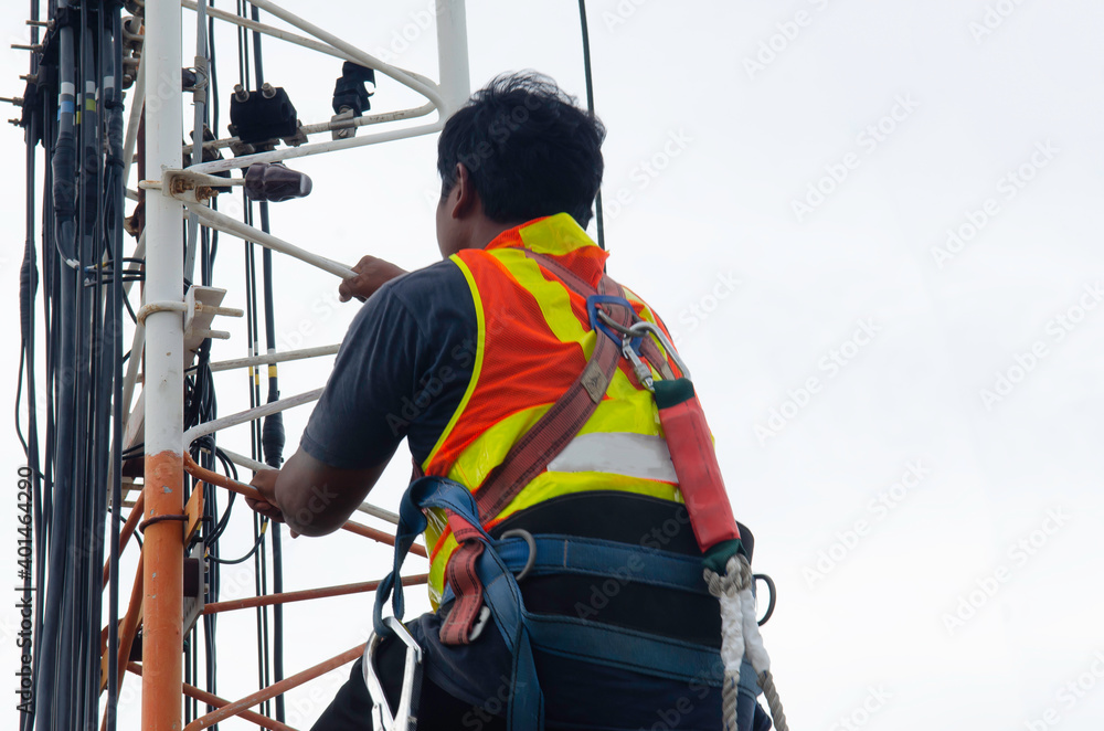 Engineer or Technician wear safety equipment climb high telecom tower ...