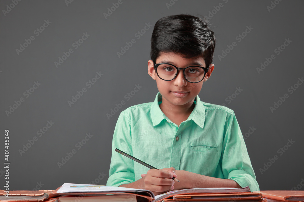 Little boy learns with his books in study room Stock Photo | Adobe Stock