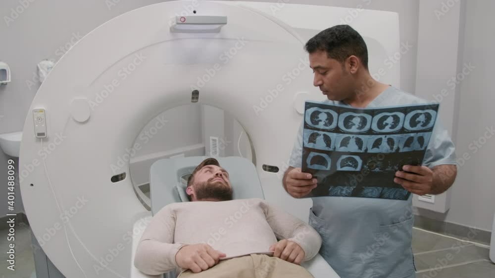 Handheld tracking of Arab male radiologist holding chest x-ray and ...