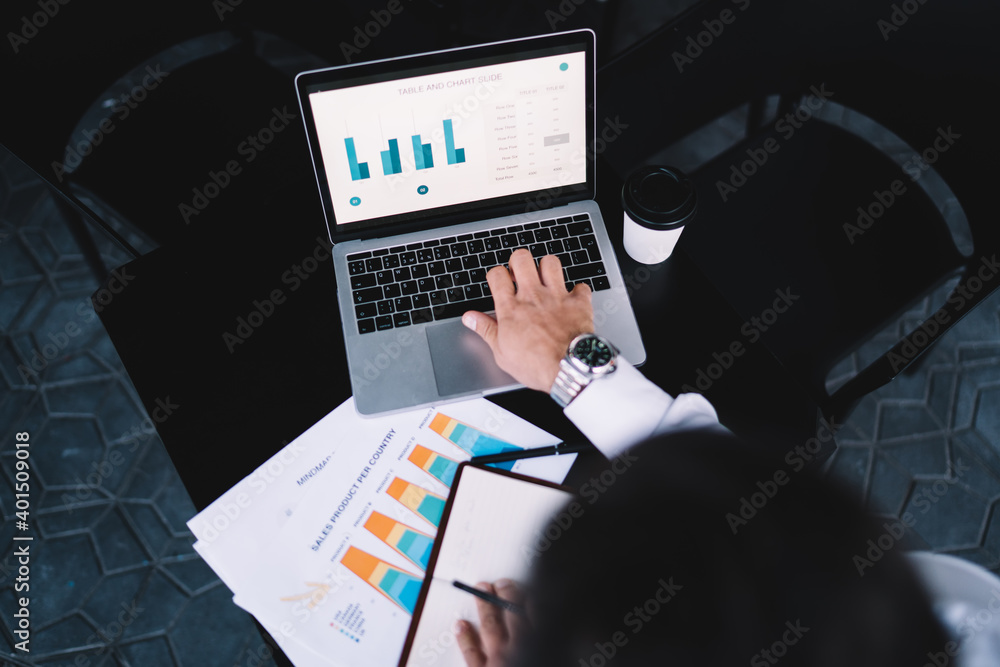 Cropped overhead view of experienced businessman analyzing revenue ...