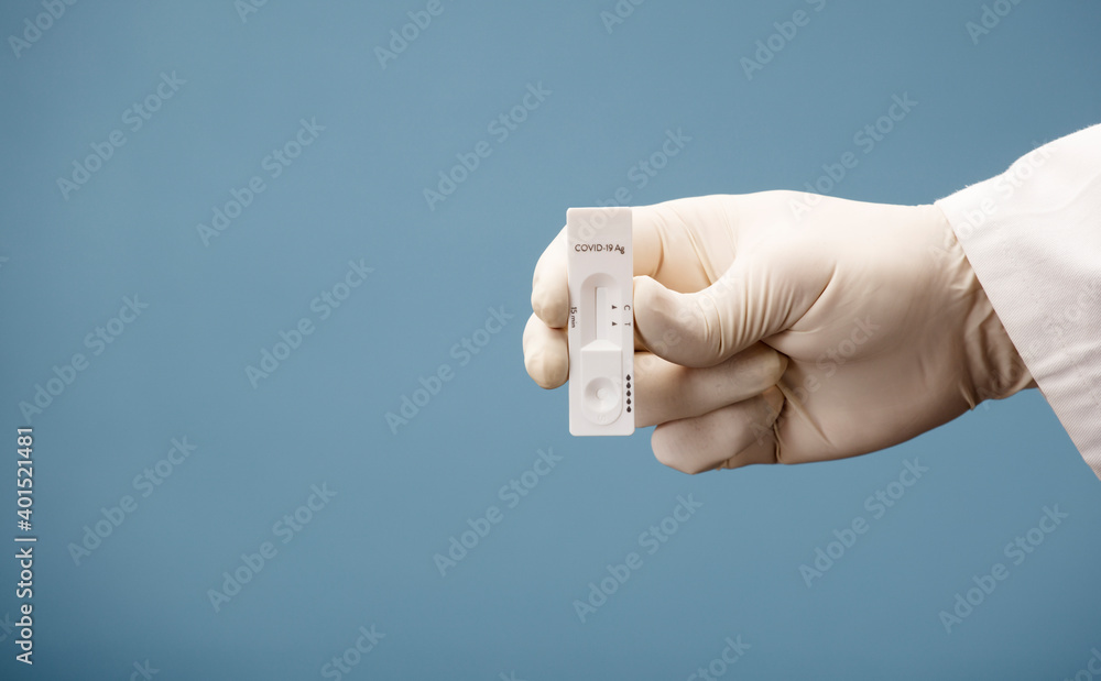 Doctor holding a test kit for viral disease tests with the COVID-19 ...
