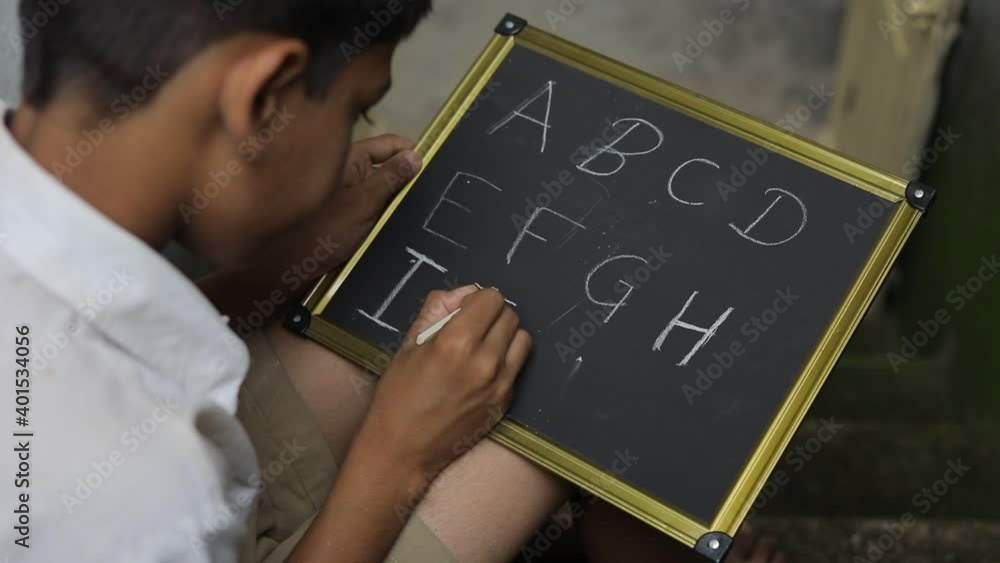 Indian child writing A B C D alphabet on Chalkboard Stock ビデオ | Adobe Stock