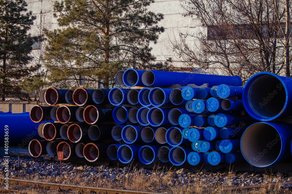 Stack of cast iron pipes in loading area waiting for transportation ...