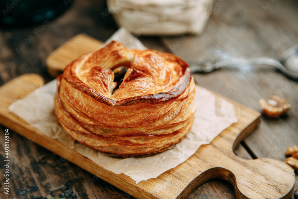 Pie with chicken and mushrooms from puff pastry. Pies cut in half close ...