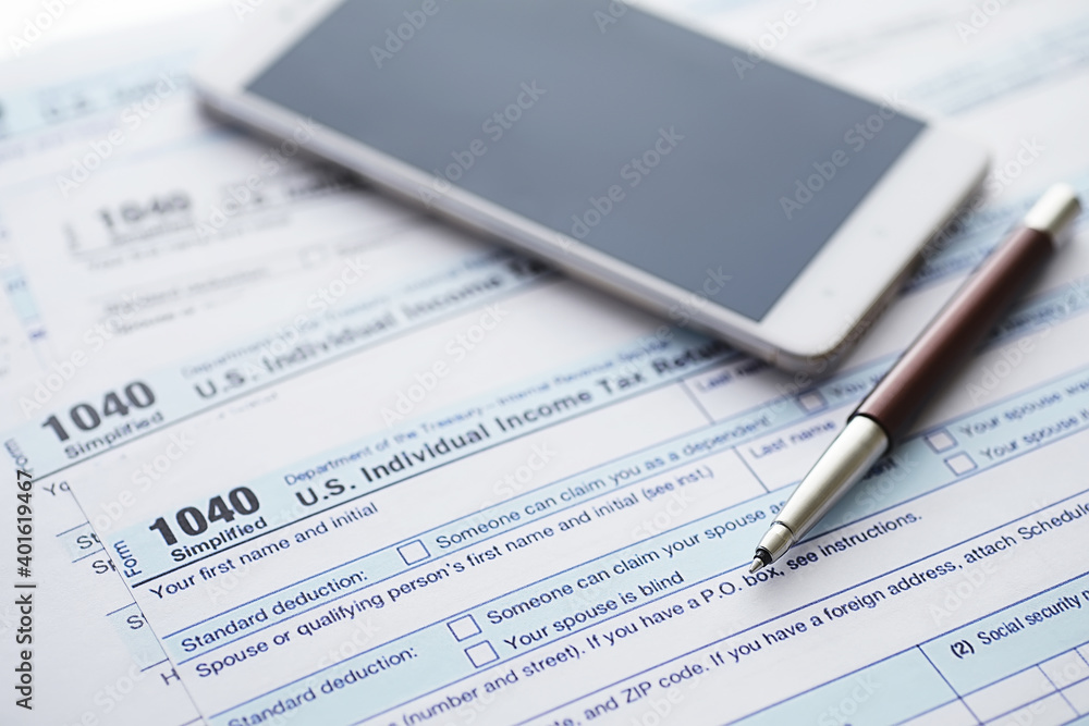 Annual tax reporting. Tax form on the table. Financial statements for ...