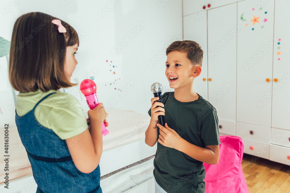 Family at home. Portrait of a happy children singing karaoke through ...