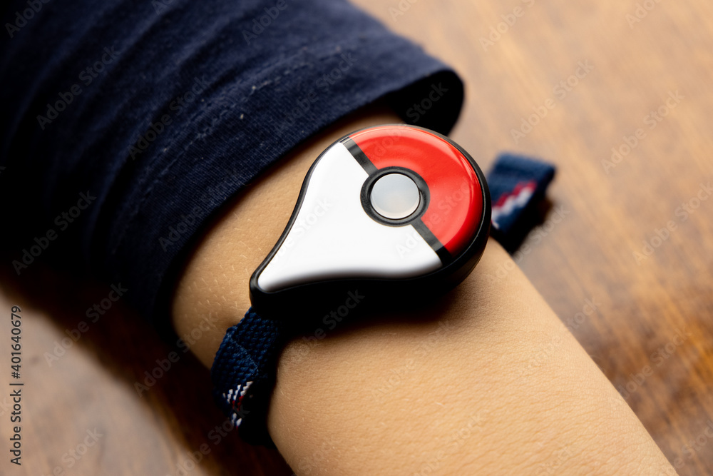 Childs hand with new Japanese game Pokemon go plus made by The Pokemon ...
