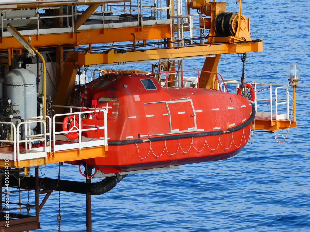 Offshore Life boat or survival craft at muster station of oil and gas ...