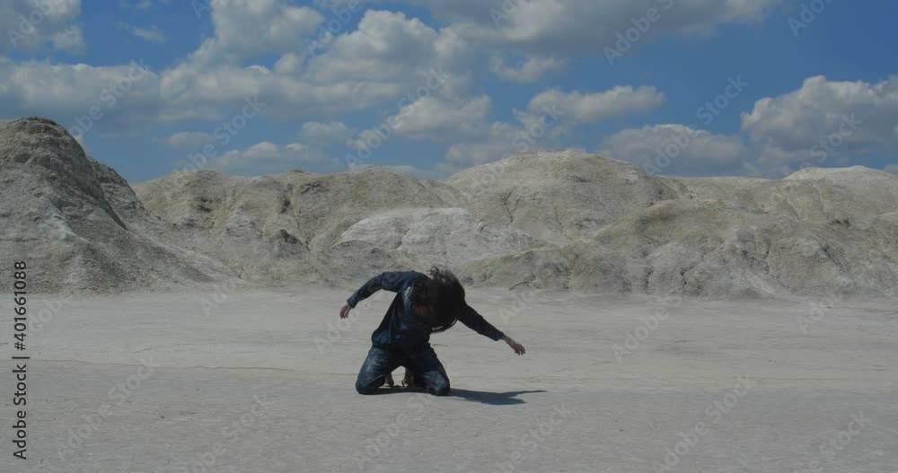 Lonely exhausted traveler goes mad in desert. Long-haired man in dirty ...