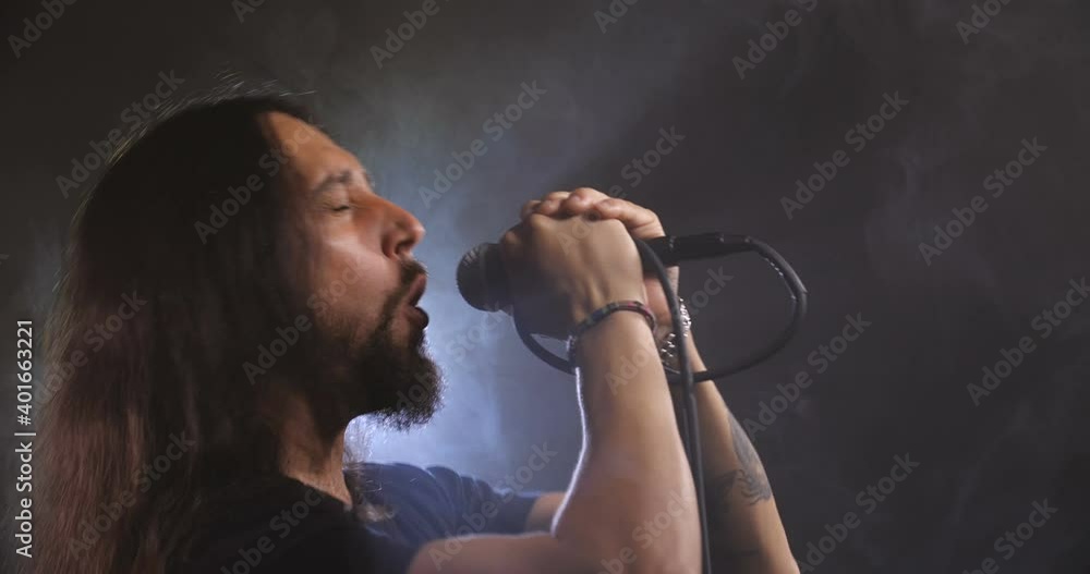 Dramatic close-up portrait of a long-haired Caucasian male, brunet with ...