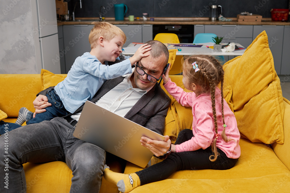 Father working from home with kids during quarantine and closed school ...