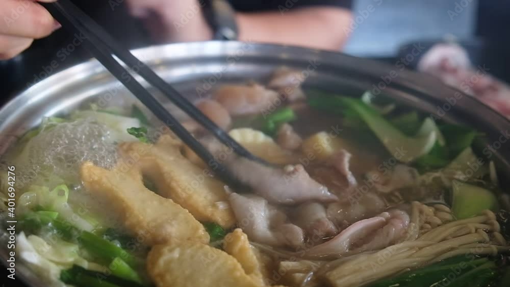 People using chopsticks eating shabu shabu is Korean or Japanese style ...