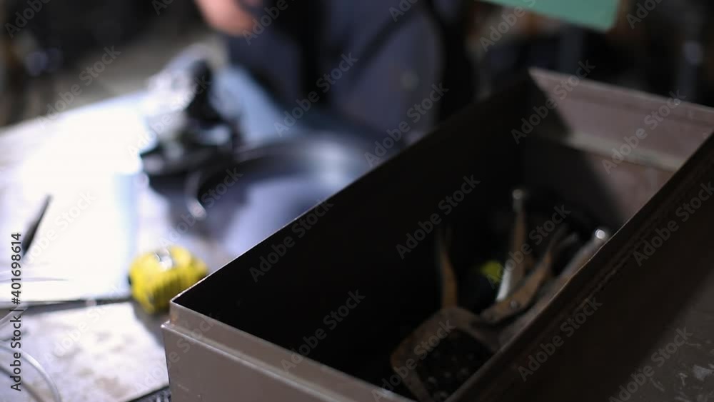 Selective focus of female blacksmith tool box on table filled with ...