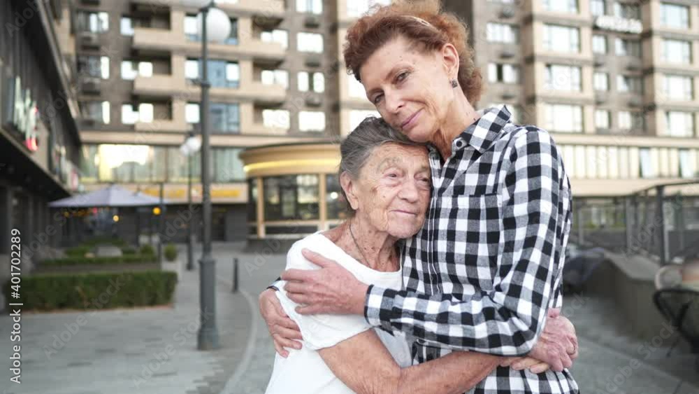 Joyful moment. Family connection. Elderly care. Daughter hugging senior ...
