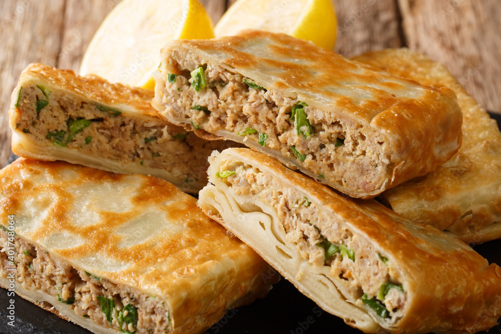 Saudi Street Food Mutabbaq with meat, egg and green onion closeup in ...