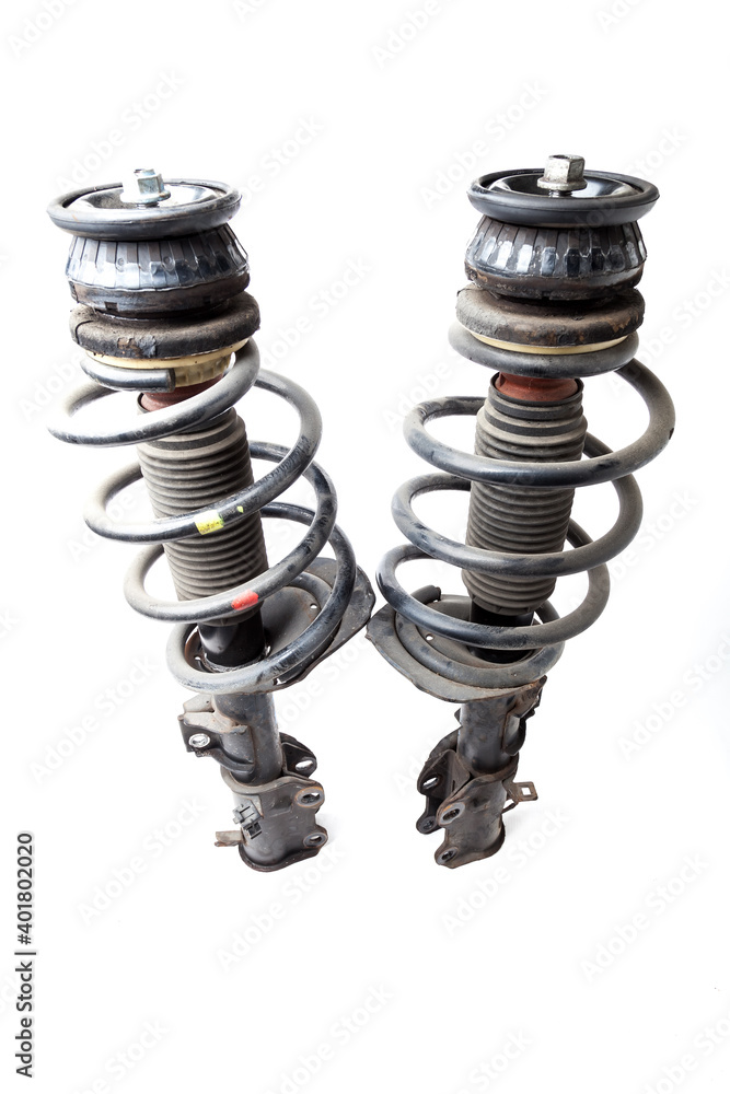 Two shock absorber struts with black springs after being used on a car ...