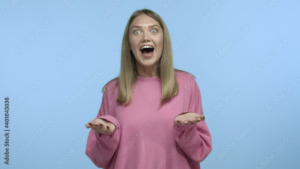 Slow motion of beautiful blond woman raising eyebrows surprised, spread ...