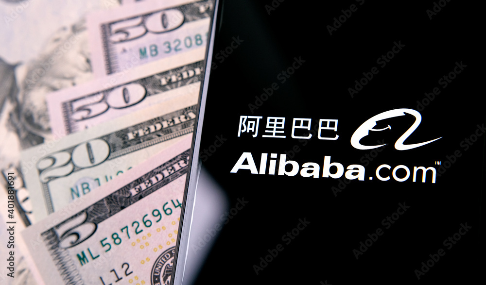Foto de Alibaba logo on a screen surrounded by dollar banknotes ...