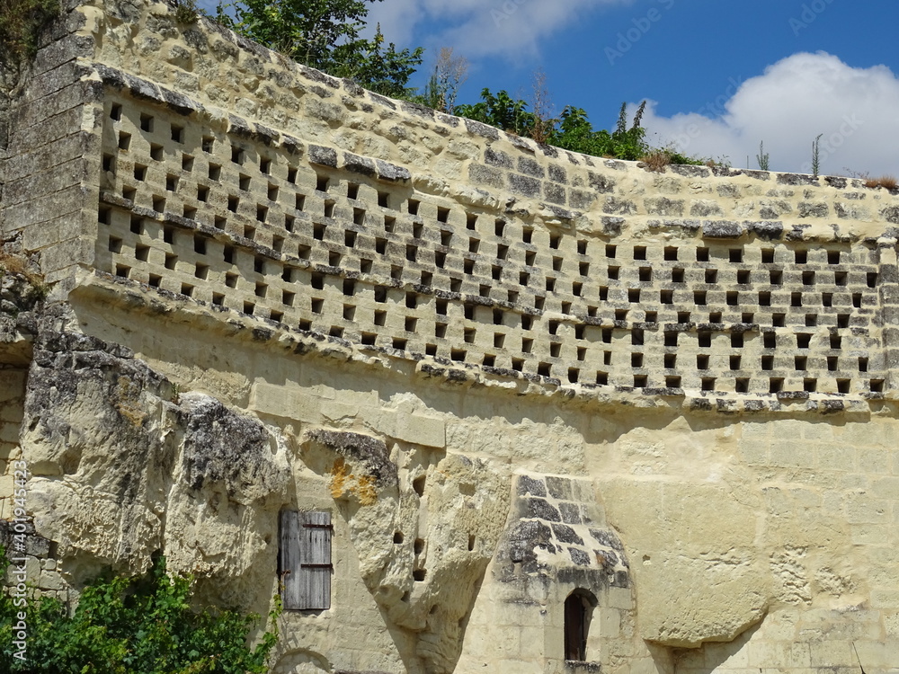 old stone dovecote built in the limestone wall in the Loire valley ...