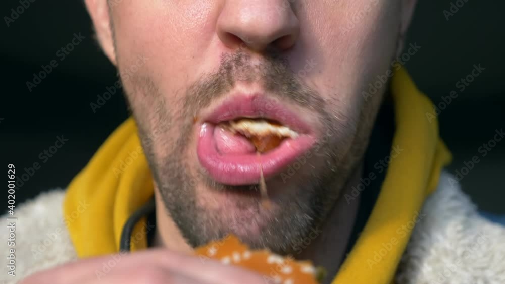 portrait of angry man eating hamburger at fast food cafe. Stock Video ...