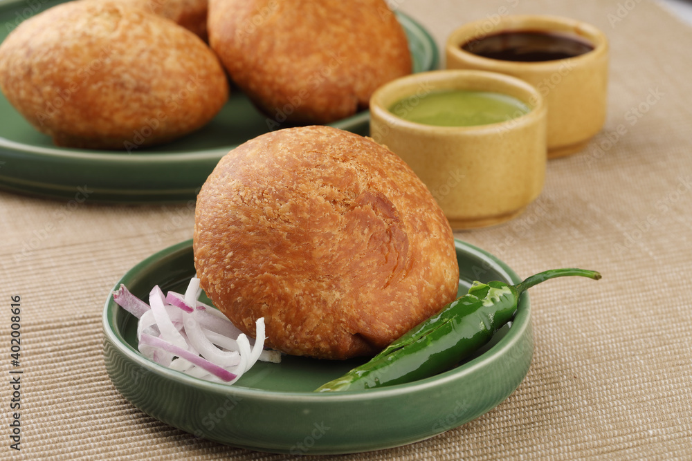 Indian teatime snack called Kachori or kachodi served with mint and ...