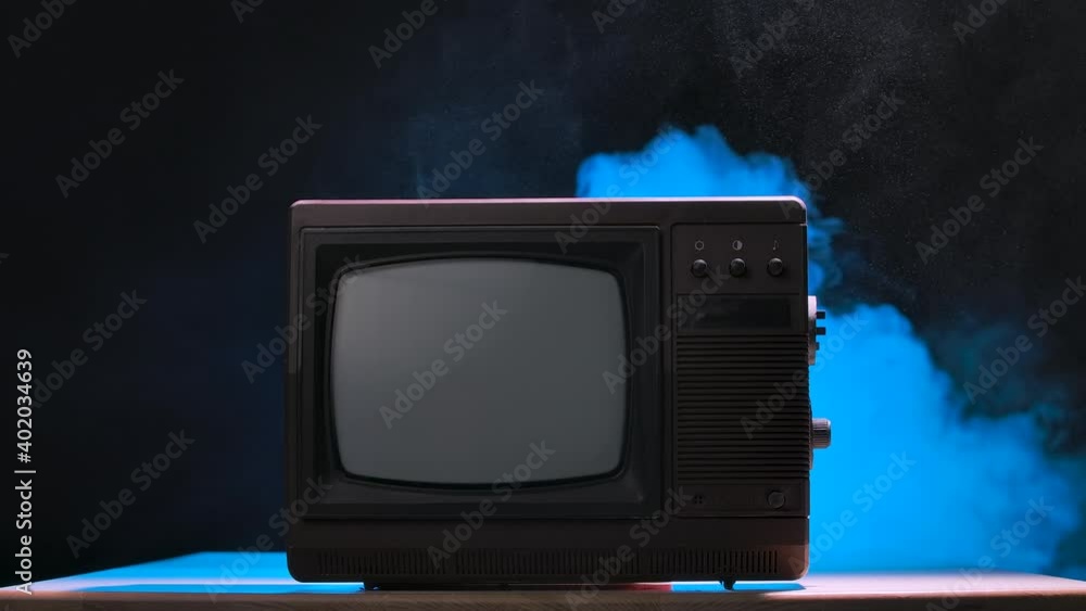 Style retro Tv set with switchers. Old fashioned TV against a smoky ...