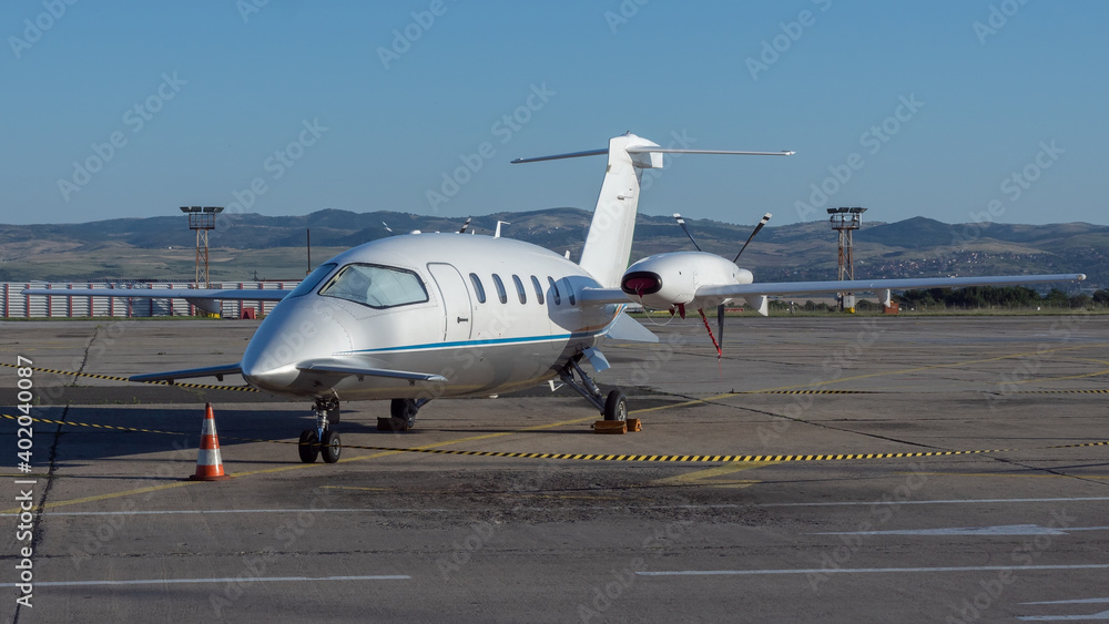 Side view of white business airplane with twin turboprop engines ...