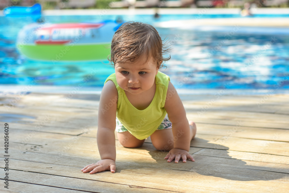 Cute adorable baby crawls near swimming pool. Summer vacation with ...