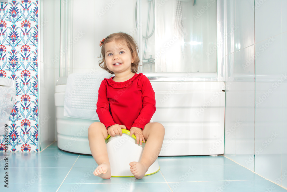 Beautiful smiling little baby sitting on potty in bathroom. Cute ...