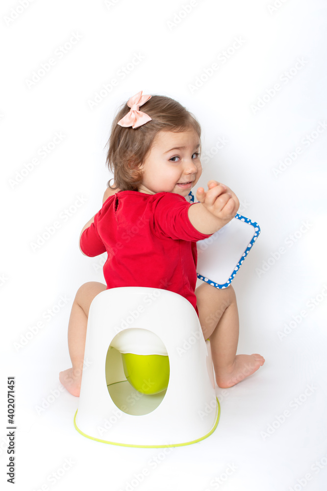 Beautiful smiling little baby sitting on potty isolated on white ...