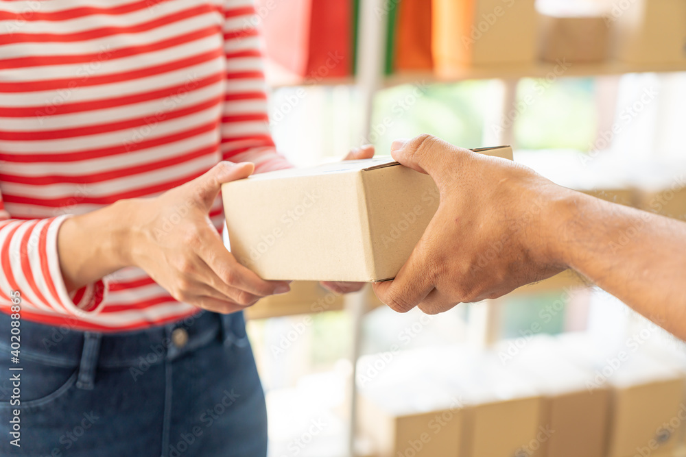 Asian woman receiving delivery package Stock Photo | Adobe Stock