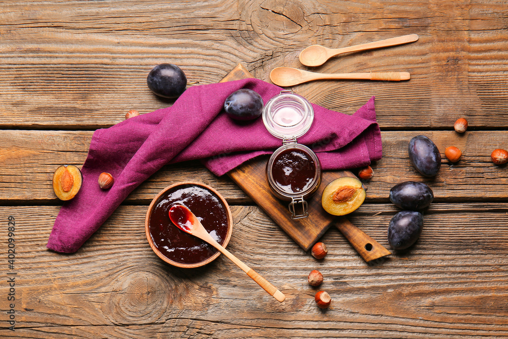 Composition with delicious homemade plum jam on wooden background Stock ...