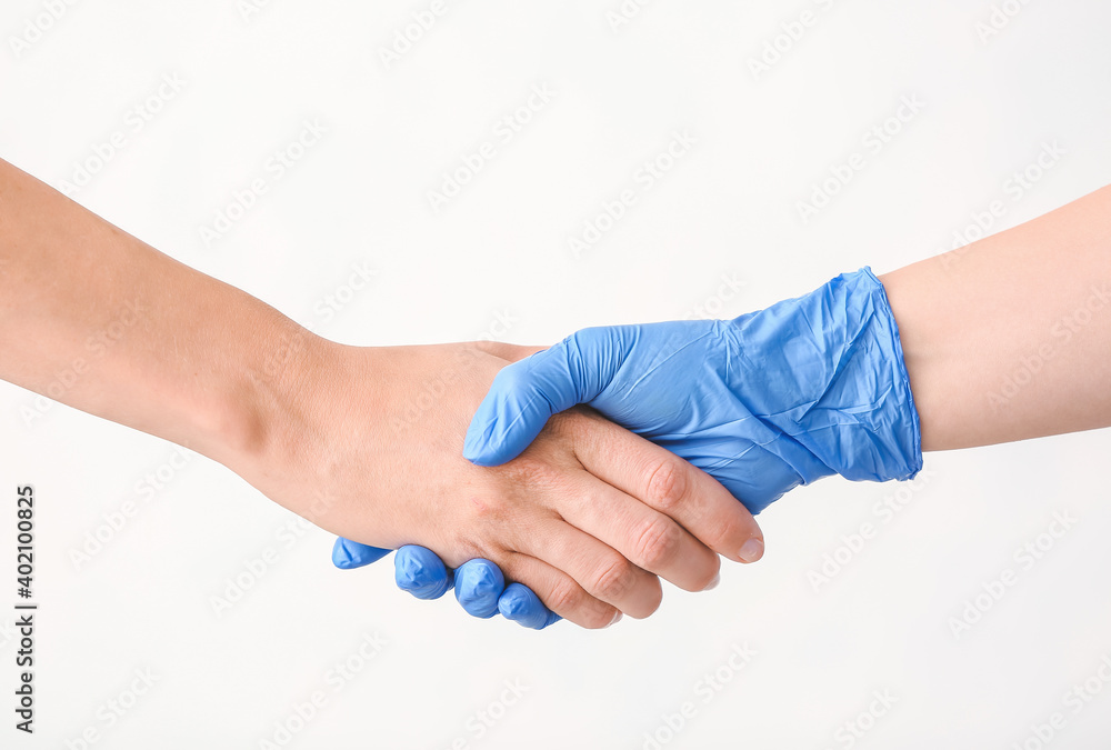 Doctor and patient shaking hands on white background Stock Photo ...