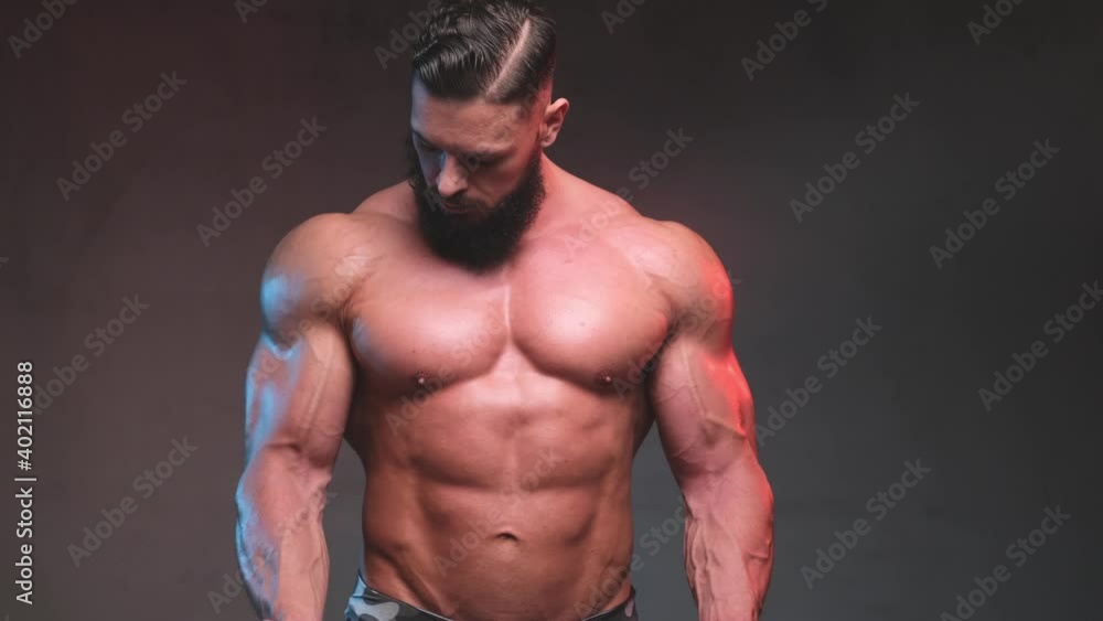 Shirtless caucasian man with muscular build and stylish haircut poses ...