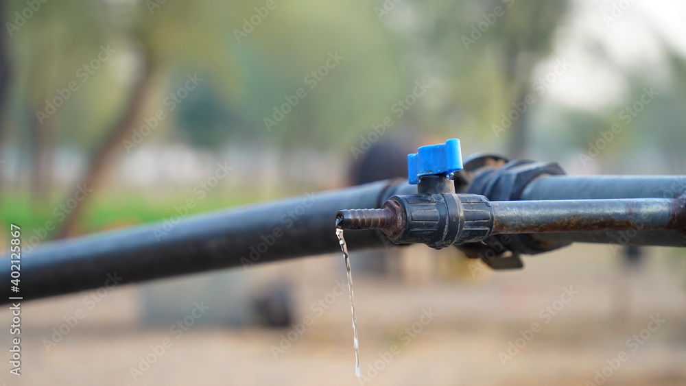 Water dropping view from blue water Valve with blurred background ...