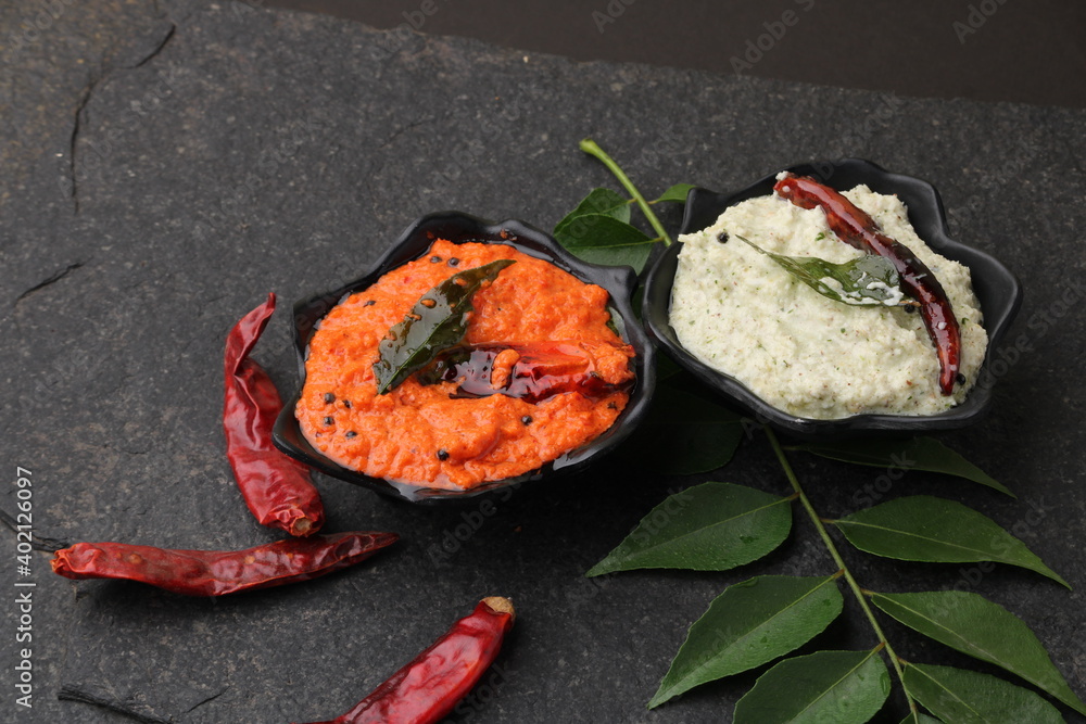 Variety of South Indian Chutney like coconut, tomato served in bowls ...